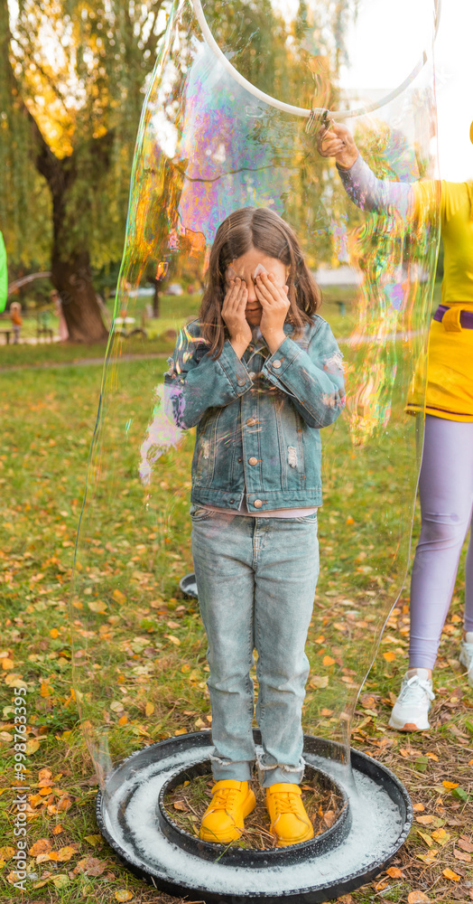 Cute little girl enjoys the bubble show at the birthday party. Stock ...