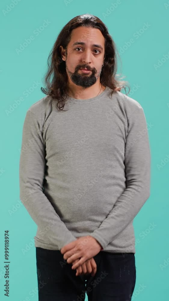 Vertical video Portrait of spiteful man making exaggerated silly faces ...