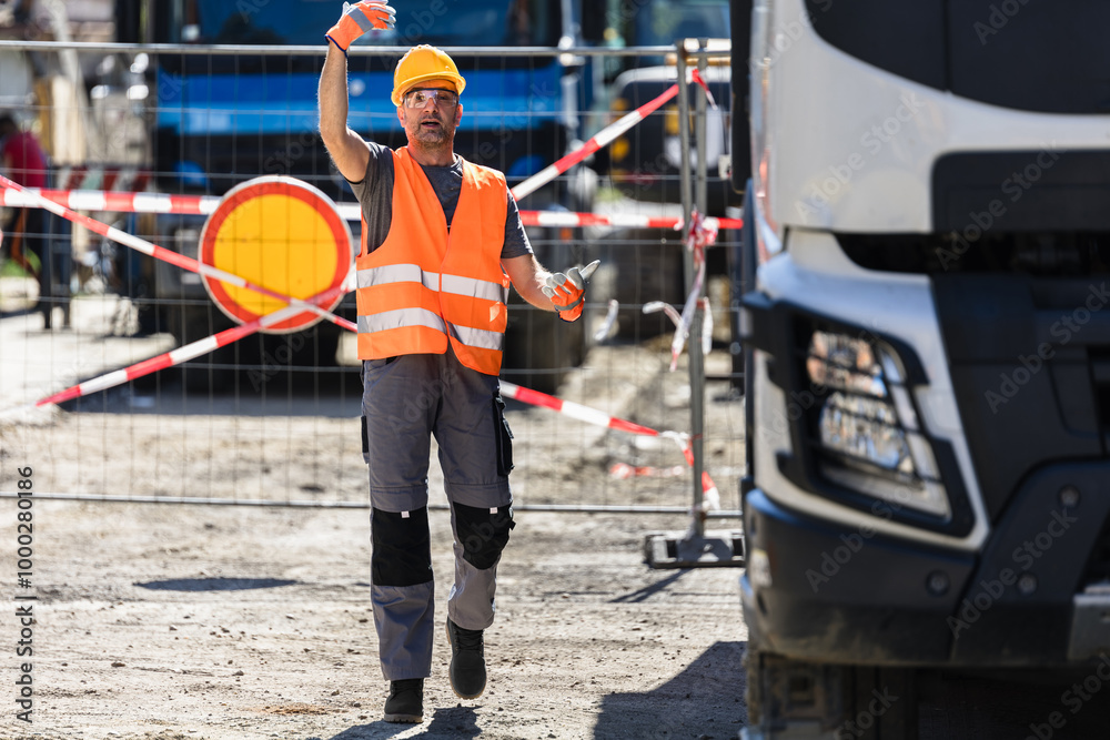 Poster Construction worker directing traffic on a busy site with safety ...