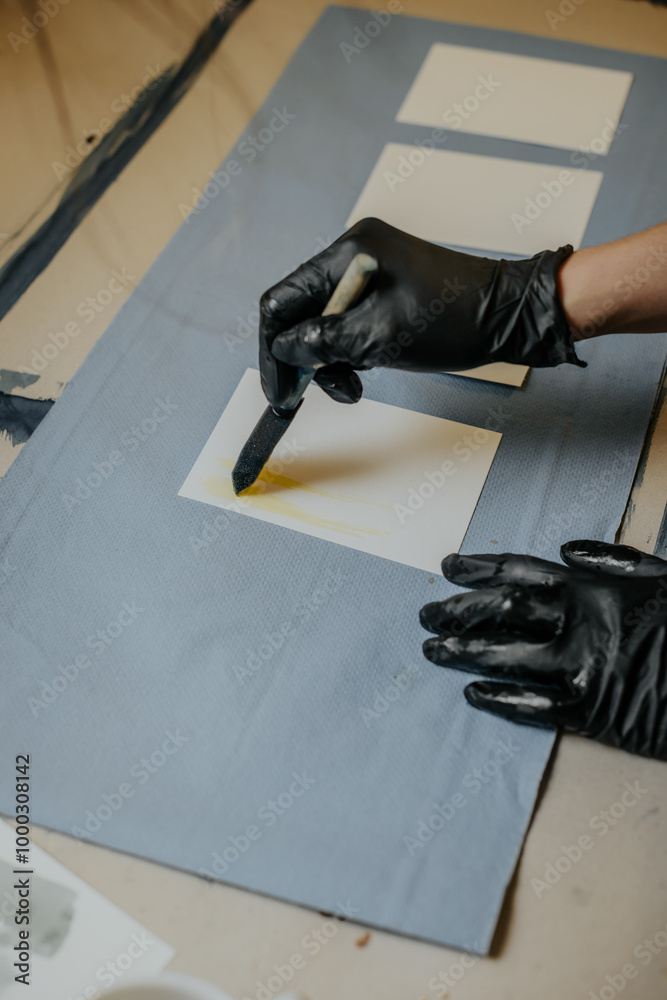 Photographer working in a lab creating custom cyanotype prints on craft ...
