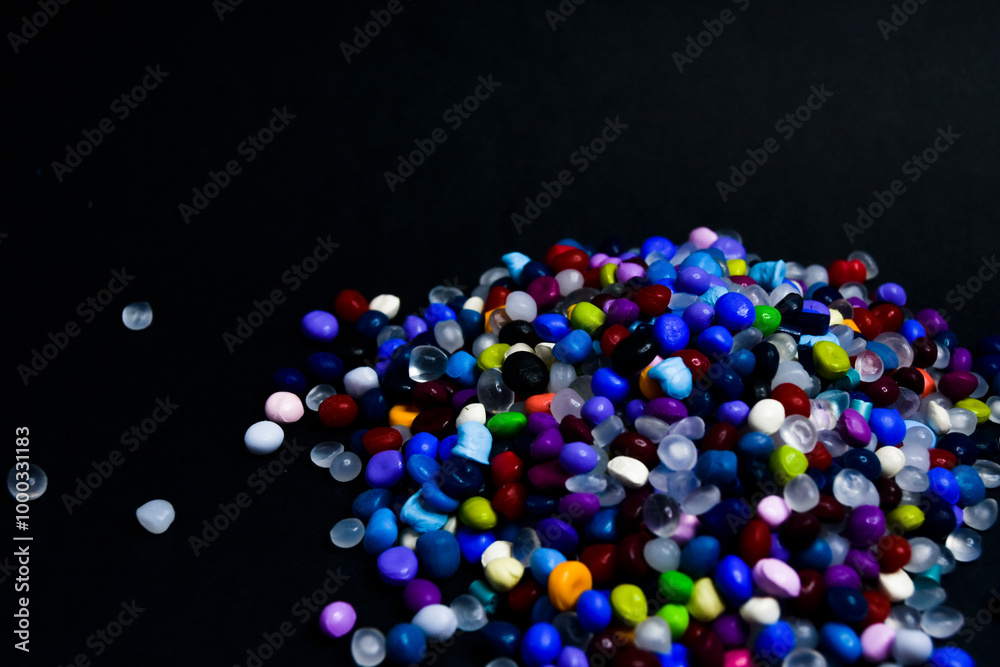 Various colors of mixed masterbatch granules, isolated on a black ...