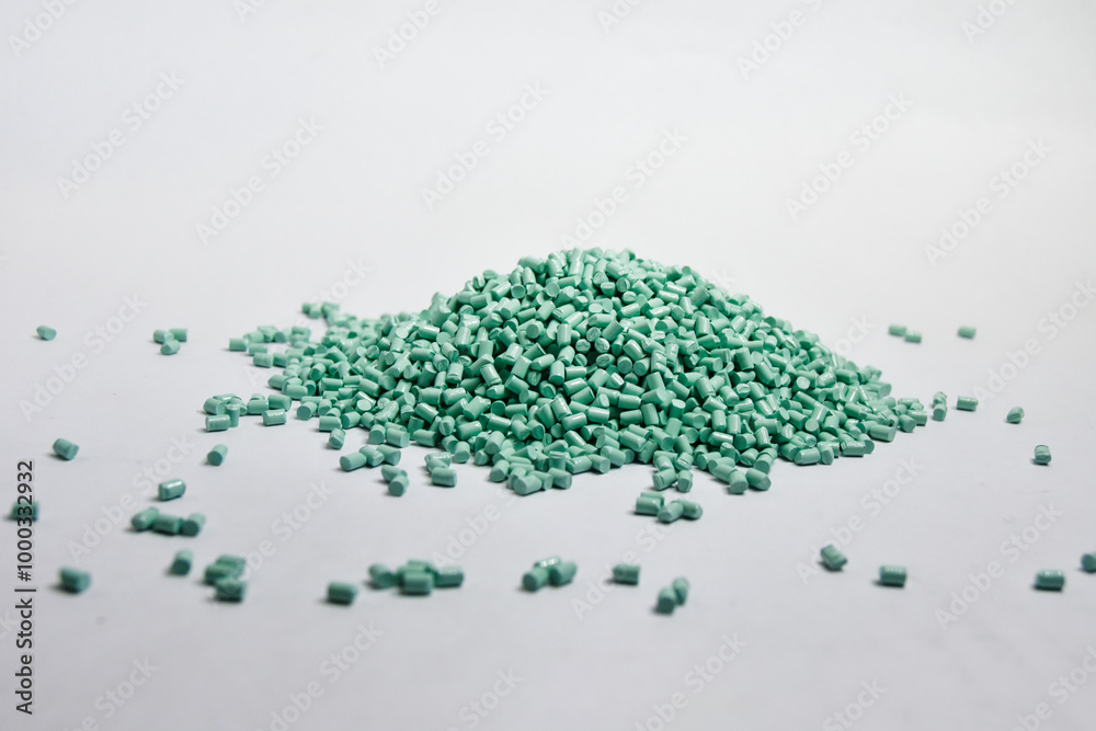 Mint green masterbatch granules on a white background, this polymer is ...