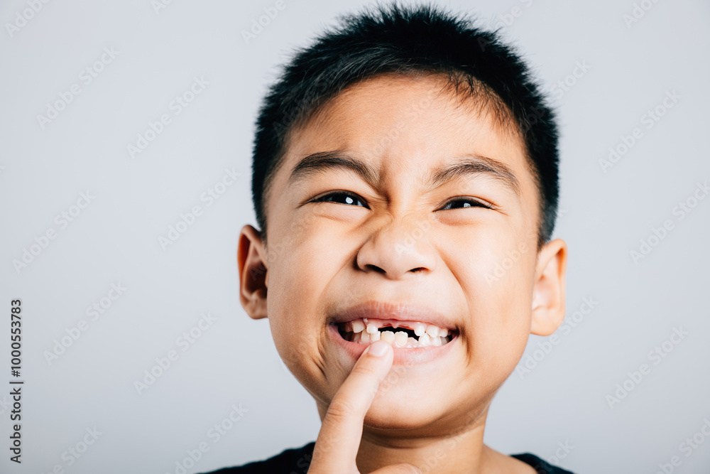 Adorable boy six smiling wide points to first permanent molar gap ...