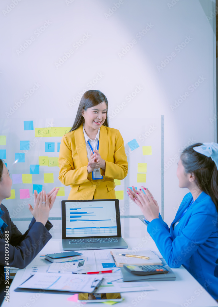 Group of business women discussing charts and graphs showing results of ...