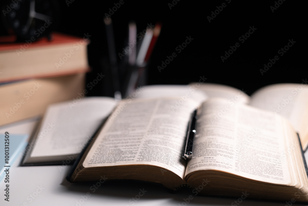 Old library, an open Bible lay on the table, its holy pages of ...