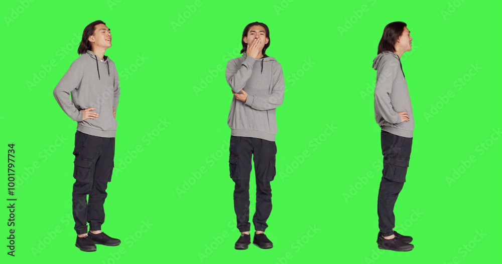 Young guy feeling sleepy and yawning after not getting enough sleep ...