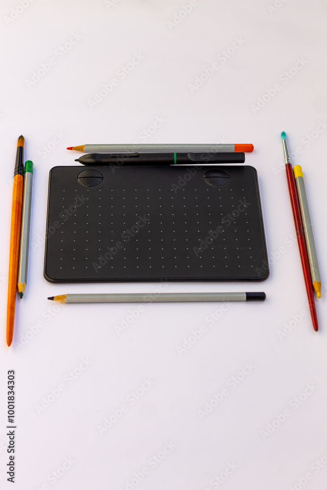Set of artist-designer, graphic tablet, brushes and pencils on a white ...