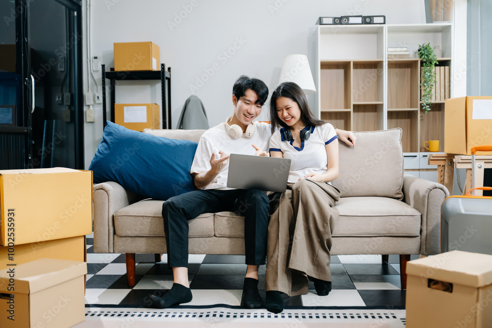 attractive couple man and woman with big boxes moving into a new house ...