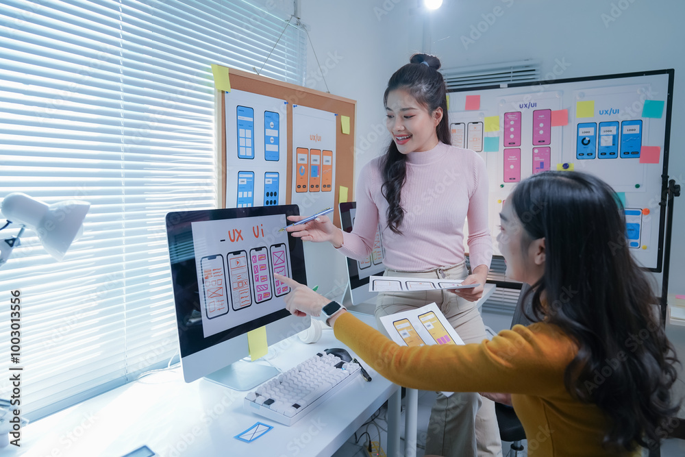 Two Asian Women Working As Ui Ux Designers Collaborating On A New Project Developing Wireframes