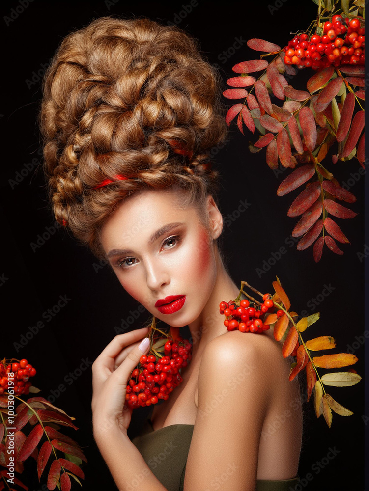 Elegant woman with long hair pinned up in a huge bun. Decorated with ...