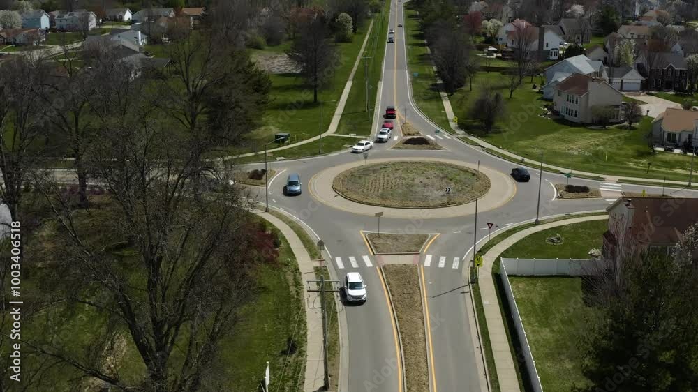 A clear view of a suburban roundabout, featuring landscaped green ...