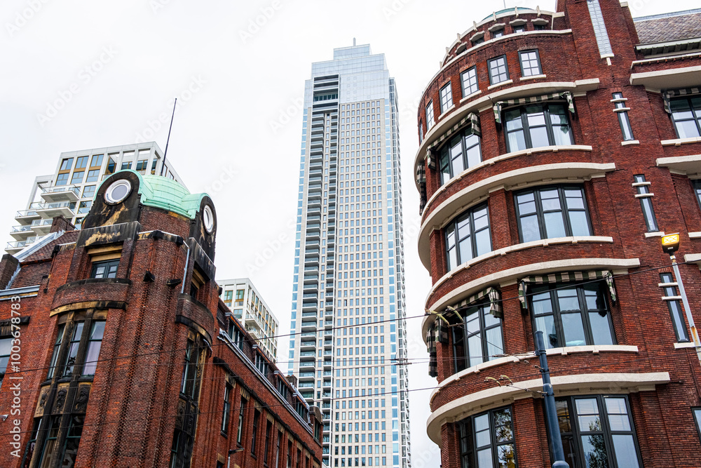 Historic red brick buildings contrast sharply with a sleek modern ...