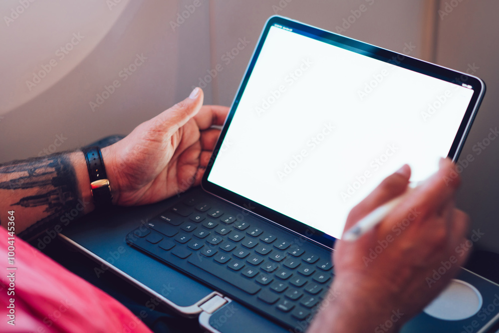 Young man flight passenger connecting to wireless internet on board ...