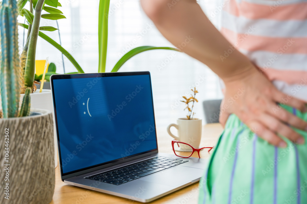 Upset young woman looking at sad laptop monitor with blue screen error ...