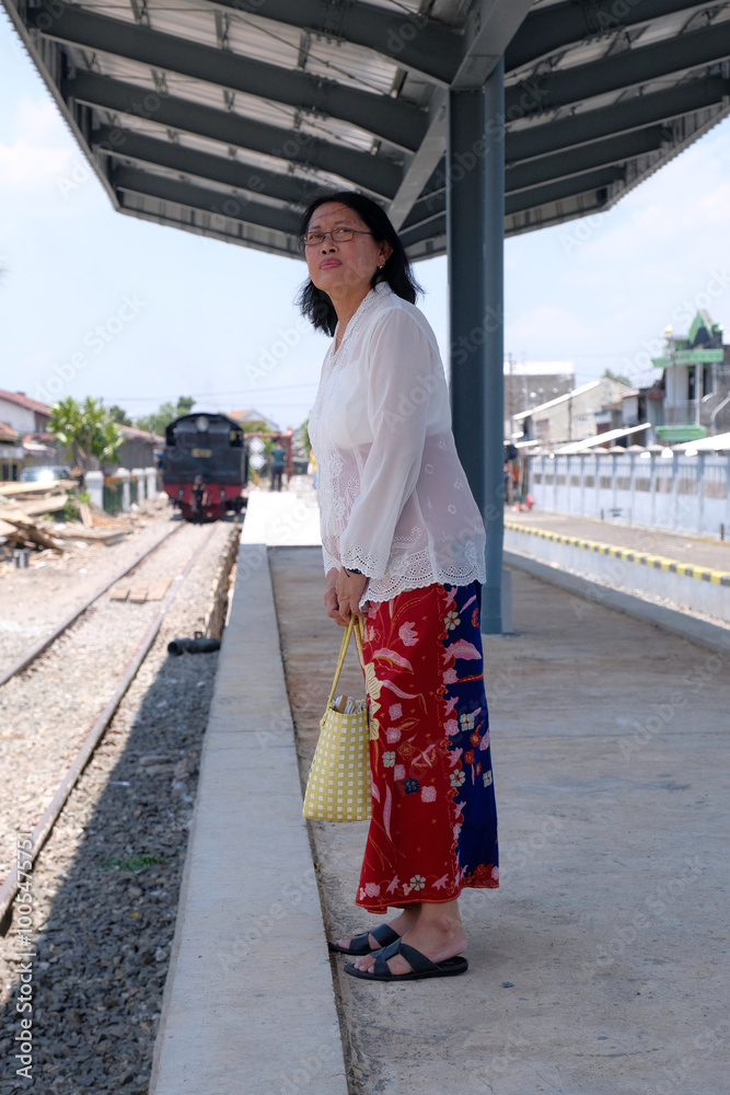 Javanese woman in her traditional dress, called Kebaya, standing on ...