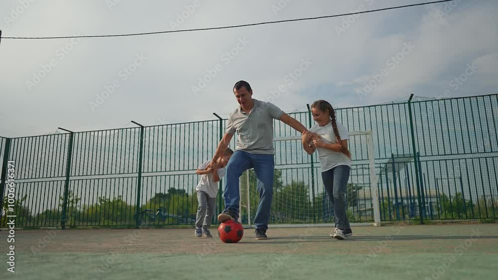 Father play with children on playground. family bonding over ball game ...