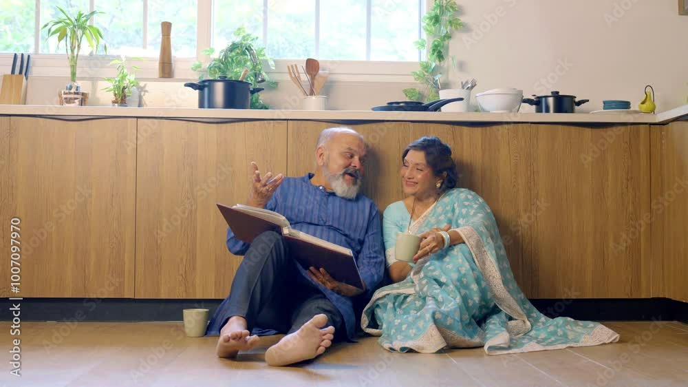 Joyful Indian Asian senior couple sitting comfortably on the floor of ...