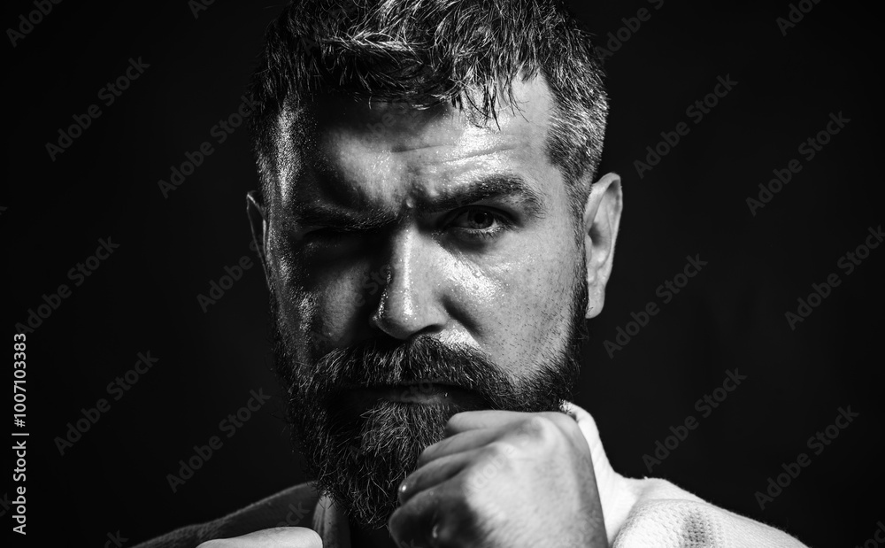 Portrait serious karate man in kimono in fighting position. Bearded man ...