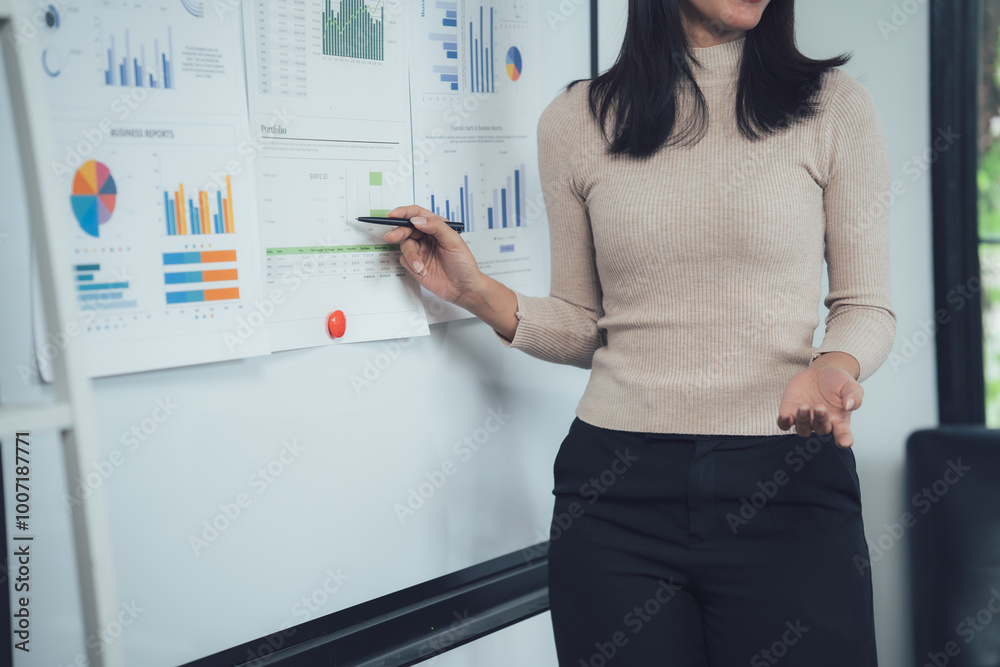 Data-Driven Insights: A confident businesswoman presents a compelling ...