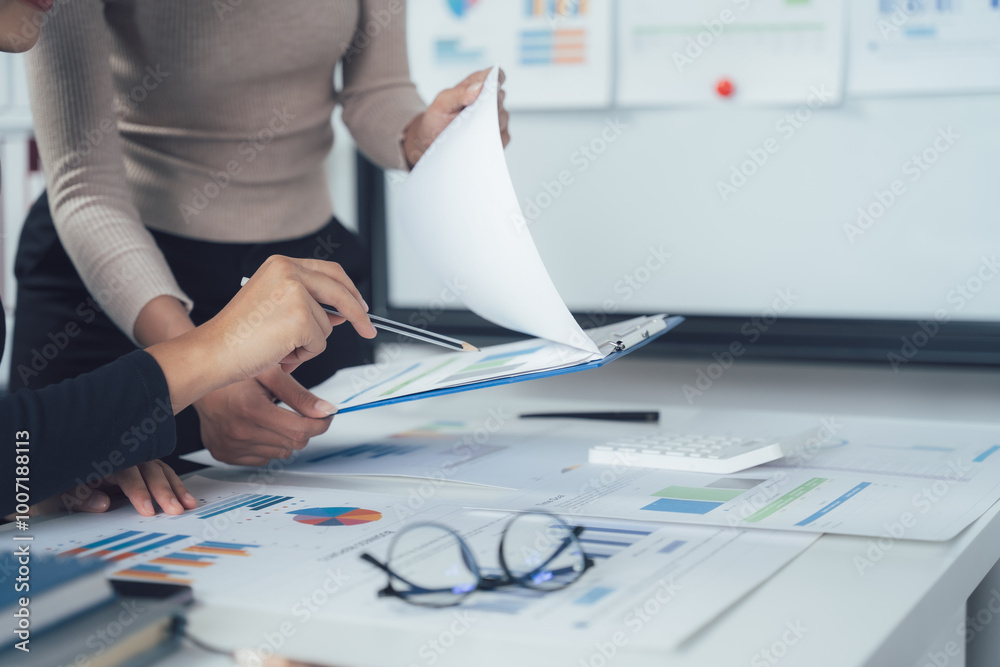 Strategic Collaboration: Business partners meticulously review ...