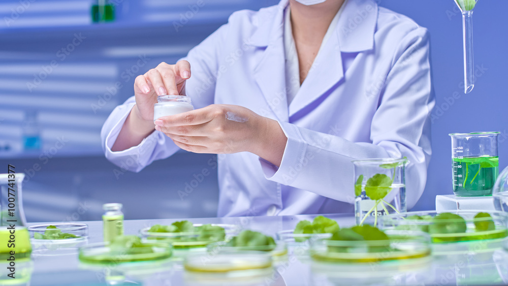 A modern lab settings shows a scientist scraping a smear of cream to ...