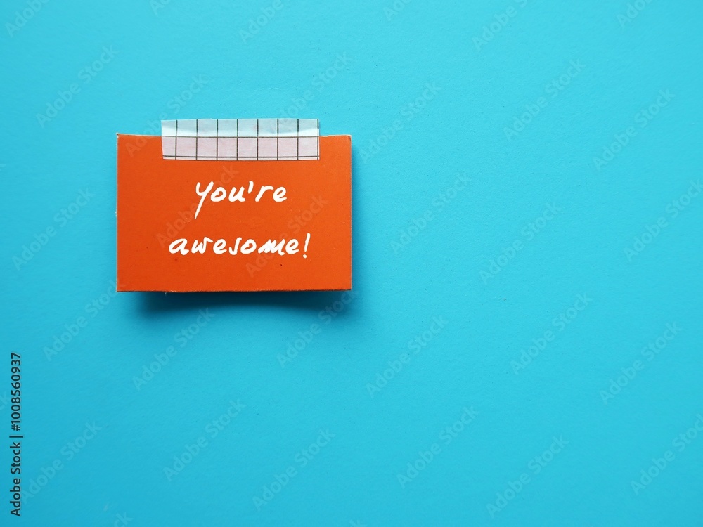 Orange paper note on copy space blue background with text written YOU ...