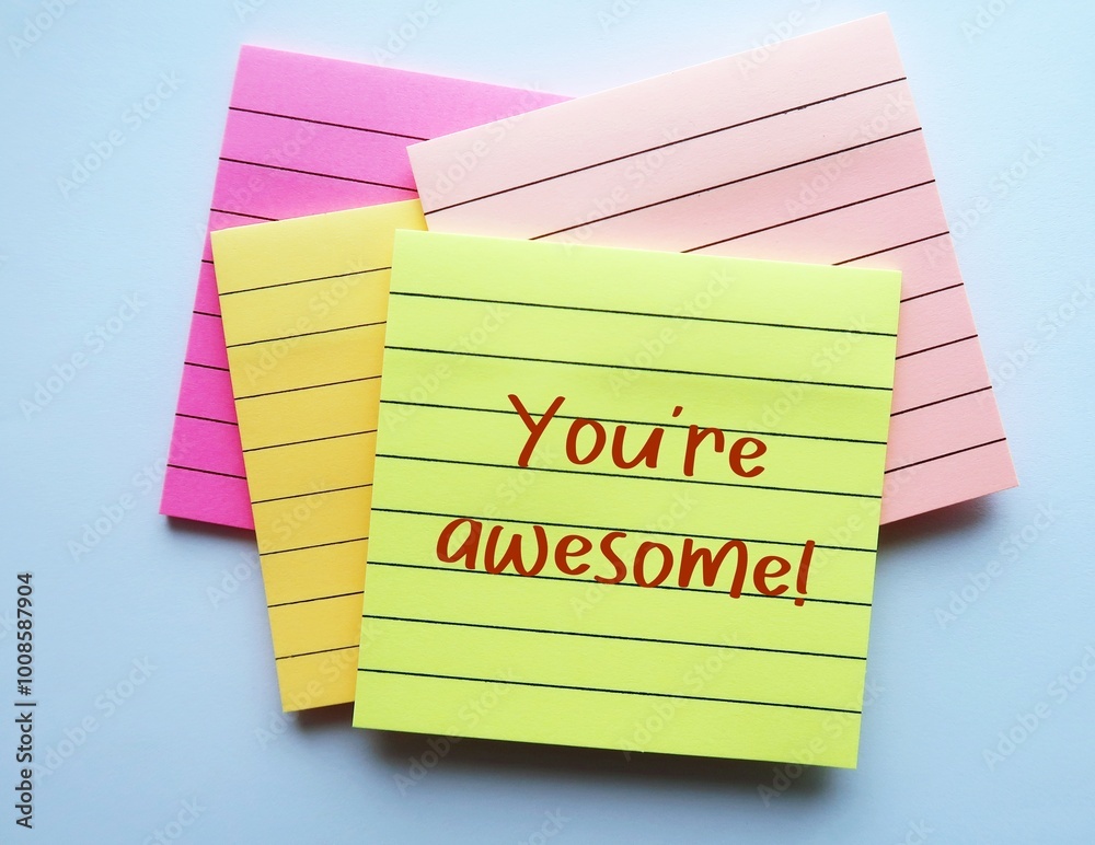 Paper note with handwritten text YOU'RE AWESOME !, to express feeling ...