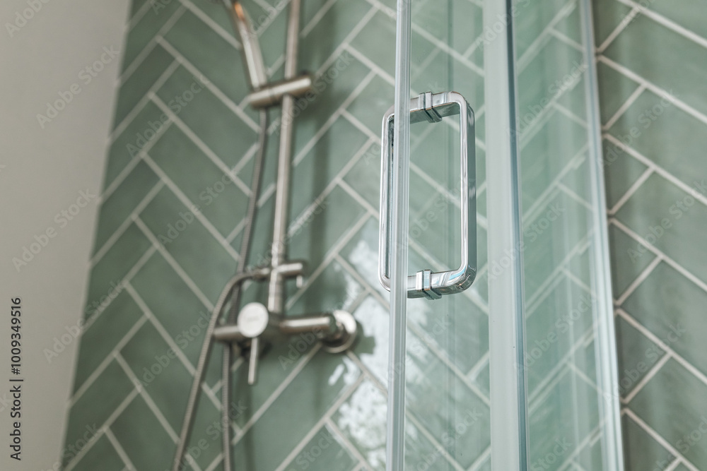 Silver Glass door handle of a glass partition shower unit. Bathroom ...