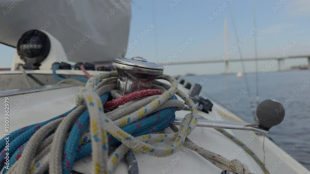 Close-up of sea knots and ropes on a floating white yacht against the ...