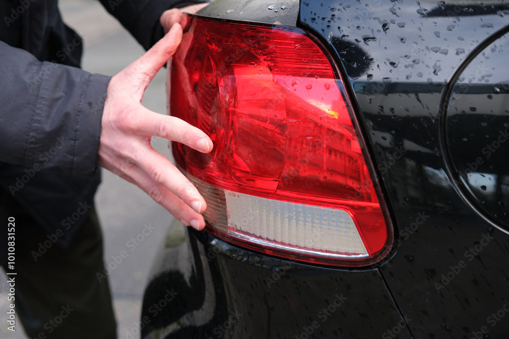 car rear lights, close-up male hands install red and white rear view ...