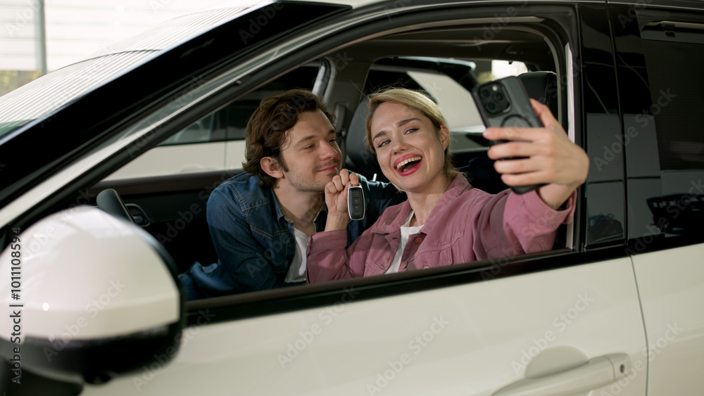 A young family is happy about buying a brand new car at a modern car ...