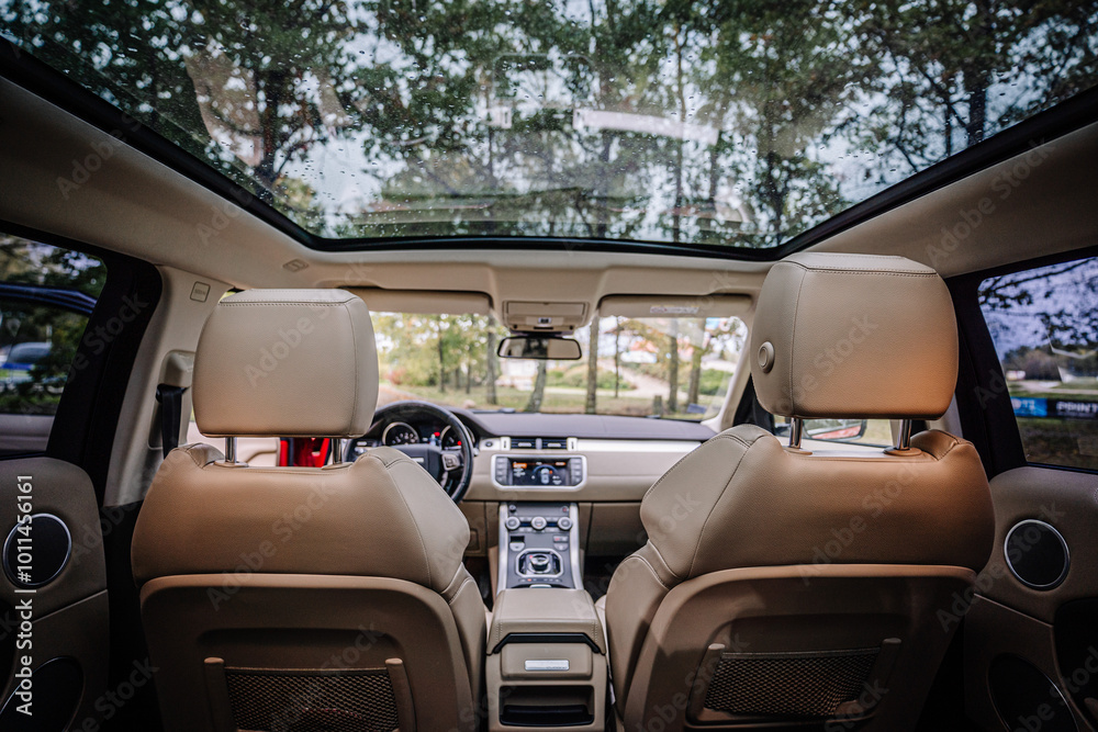 Interior view of a Range Rover featuring beige leather seats and a ...