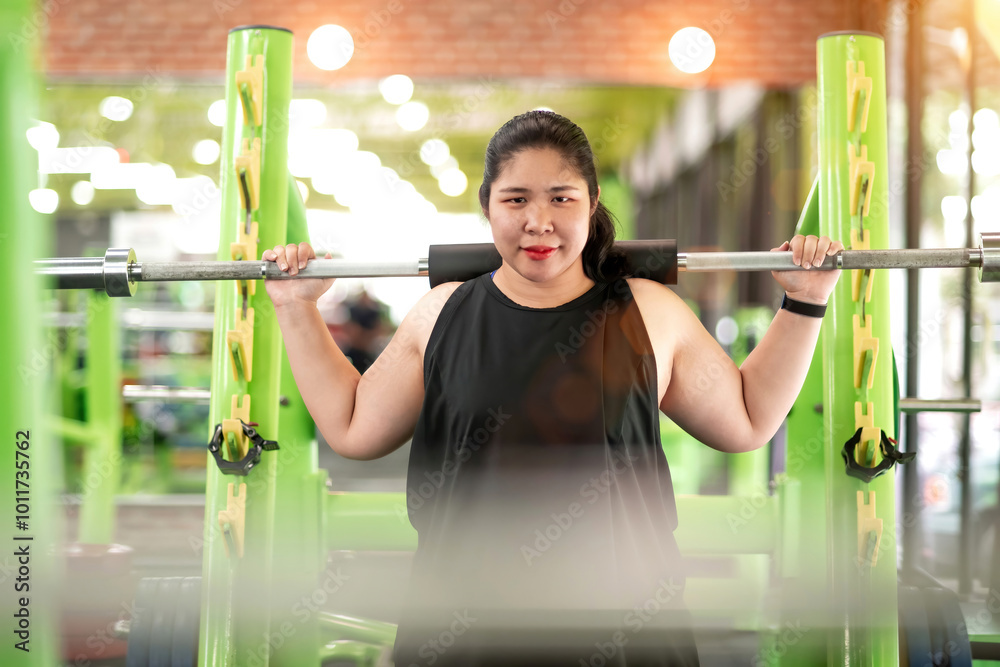 fat motivated woman exercise lifting barbell. determined chubby ...