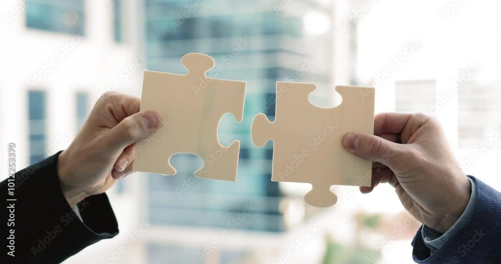 Close up two businessmen connecting jigsaw puzzle pieces, find right ...
