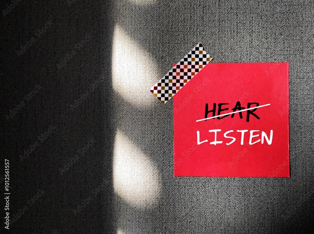 On wallpaper background, red note with handwritten text HEAR replaced ...