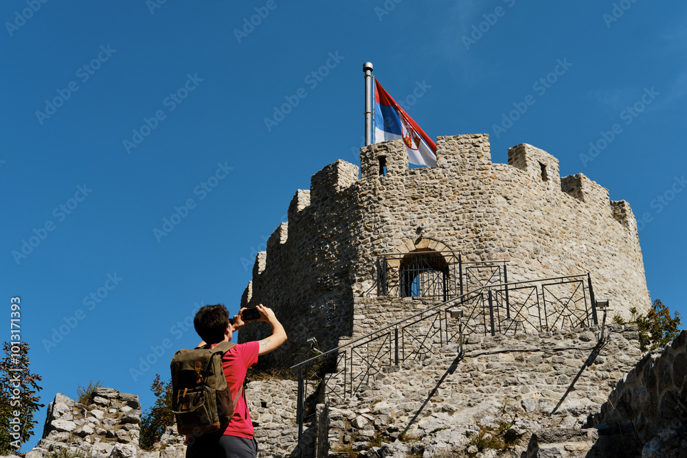 Old Town Fortress of Uzice in Serbia country. A young female traveler ...