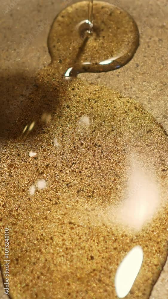 Sunflower oil flows into non stick frying pan, spreading across hot ...