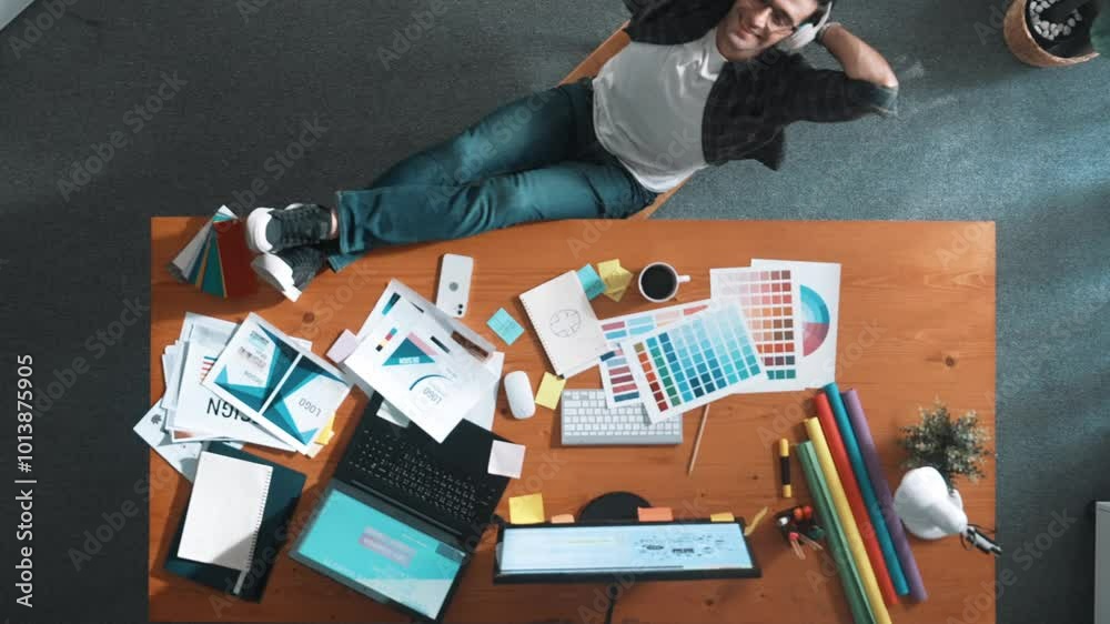 Time lapse of relaxed project manager drinking a coffee while design ...