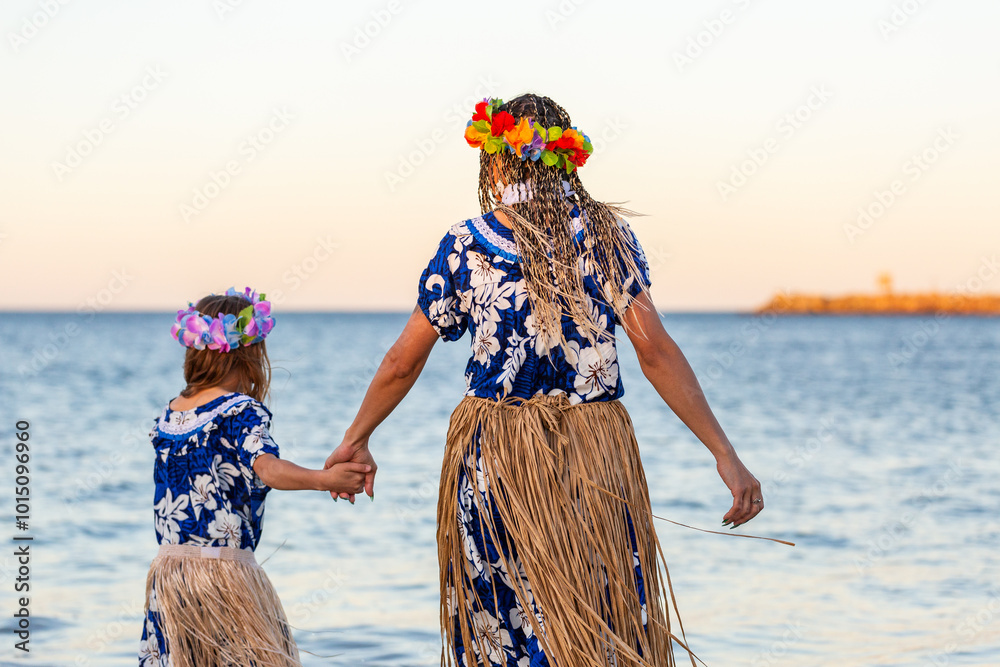 Torres Strait Islander mother and young daughter in traditional floral ...