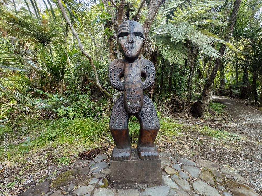 Native Maori sculture in a forest on the Cascade Kauri walk, Waitakeres ...