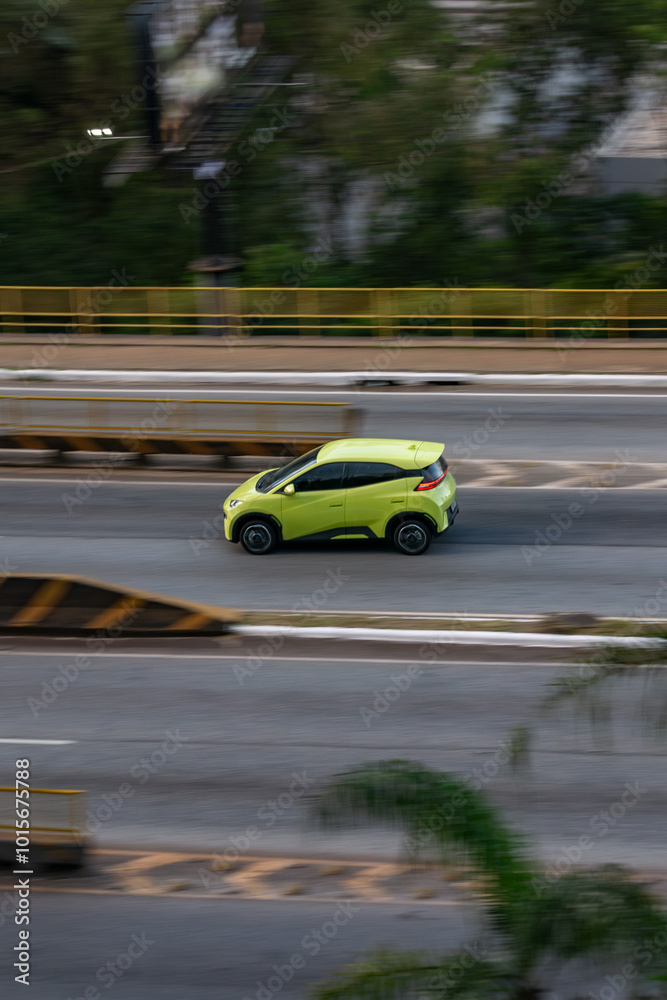 Green BYD Dolphin Mini cruising city highway, Compact electric car in ...