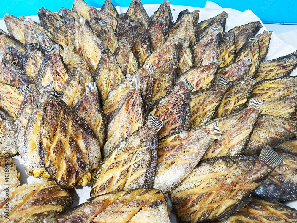 Deep fried Snakeskin gourami fish with spawns on white arches oil paper ...