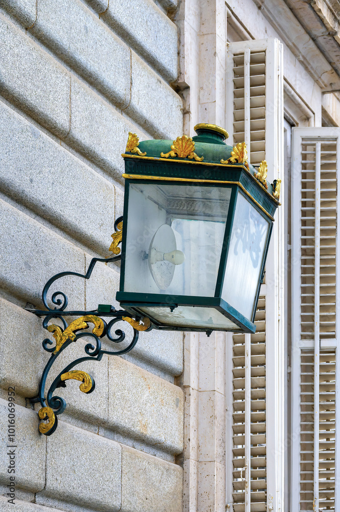 Ancient street light on the exterior walls of the Royal Palace, Madrid ...