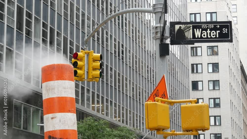 Steam vapor vented on New York City Water street, orange vapour tube ...