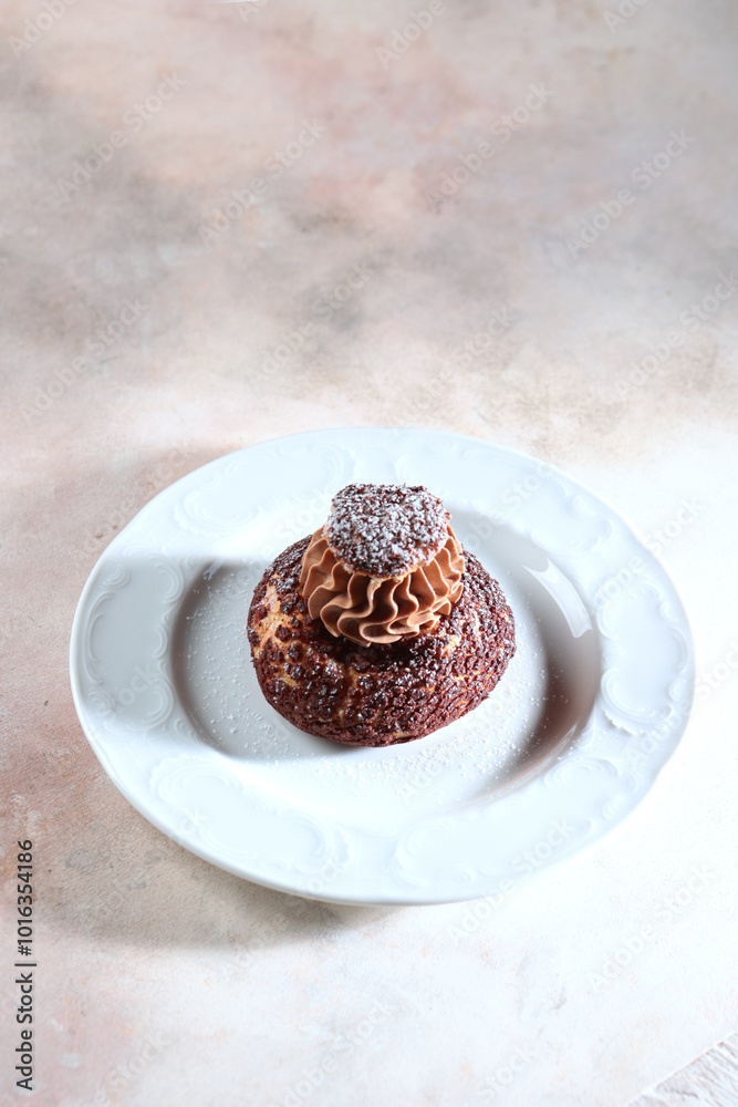 A pastry with custard cream. French Shu cake with peach jam. A modern ...