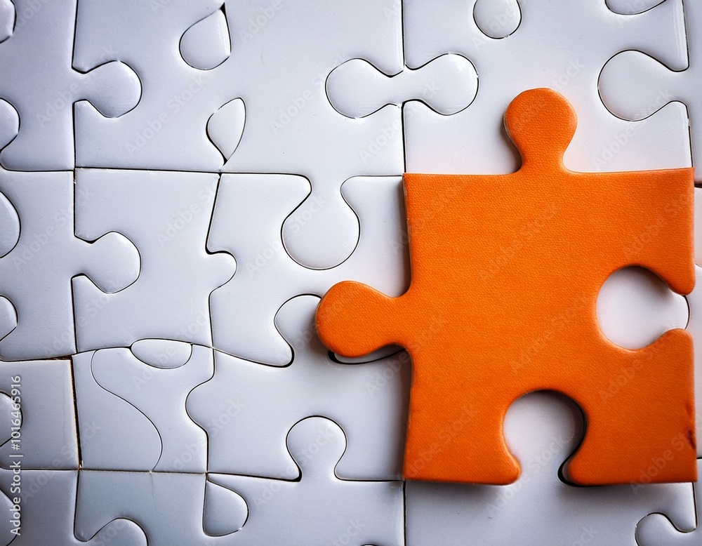 Picture of an orange puzzle piece that fits into a white puzzle. Teamwork, solutions, and ...