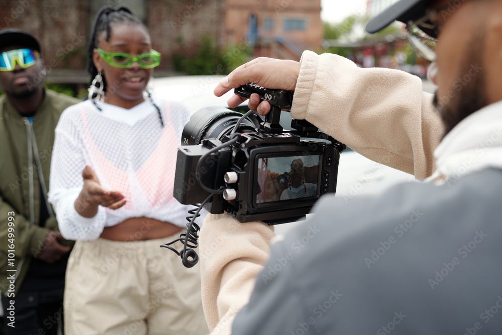 Person filming a street interview with modern camera equipment ...