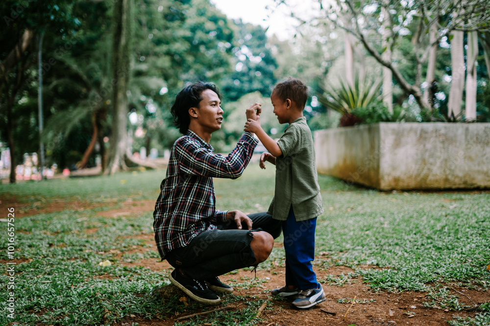 Father and son playing together, capturing a moment of joy and bonding ...