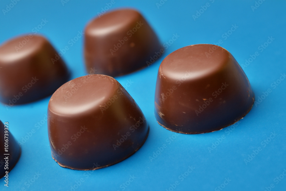 Chocolate candies in blue on. food sweet candy concept. a round candies ...
