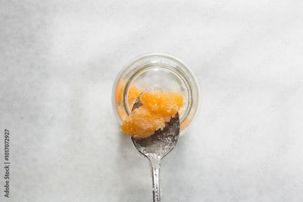 Overhead view of tangerine cheong in a spoon on a white background, top ...